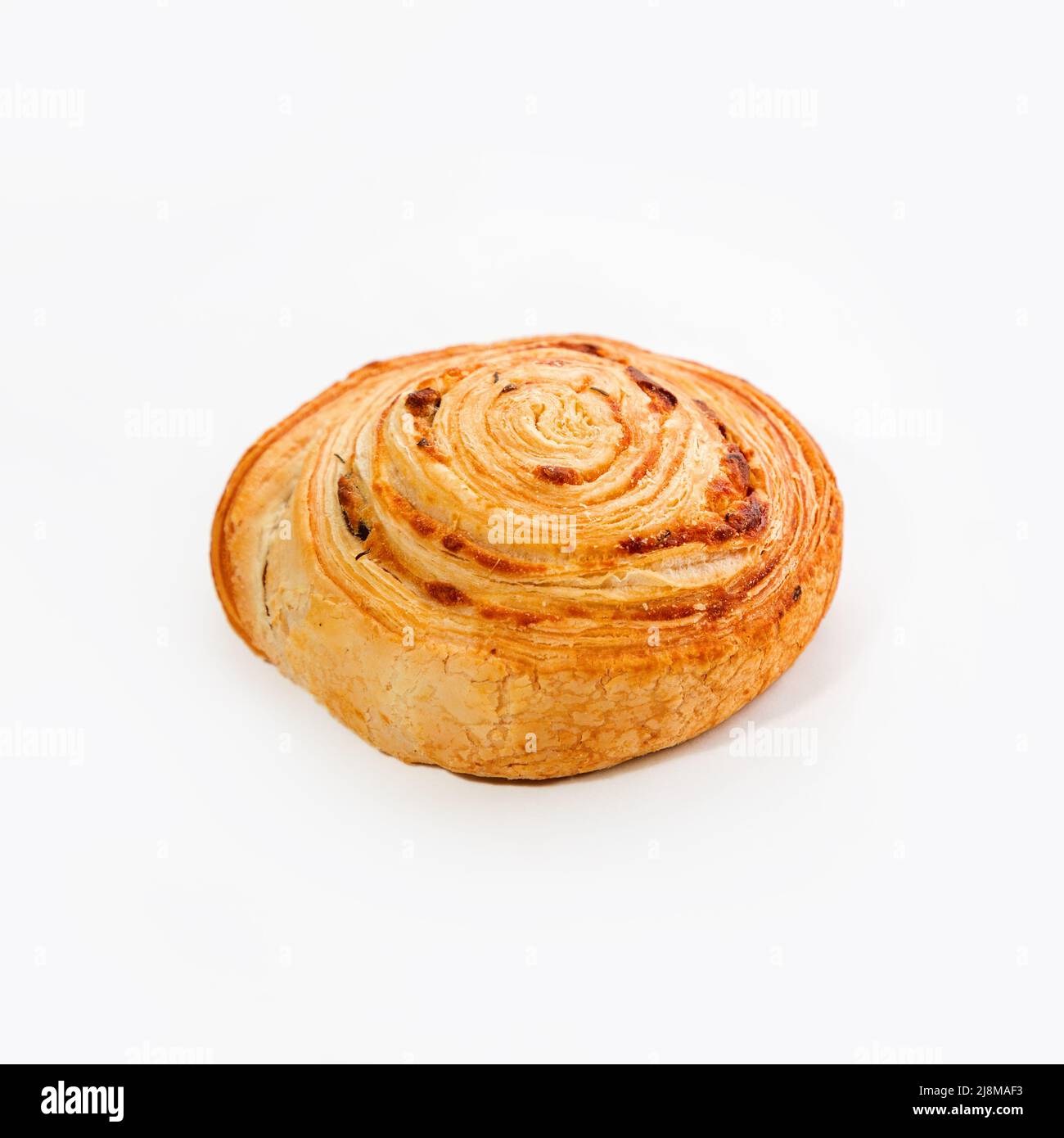 Crispy appetizing snail-bun made of puff pastry, close-up. White ...