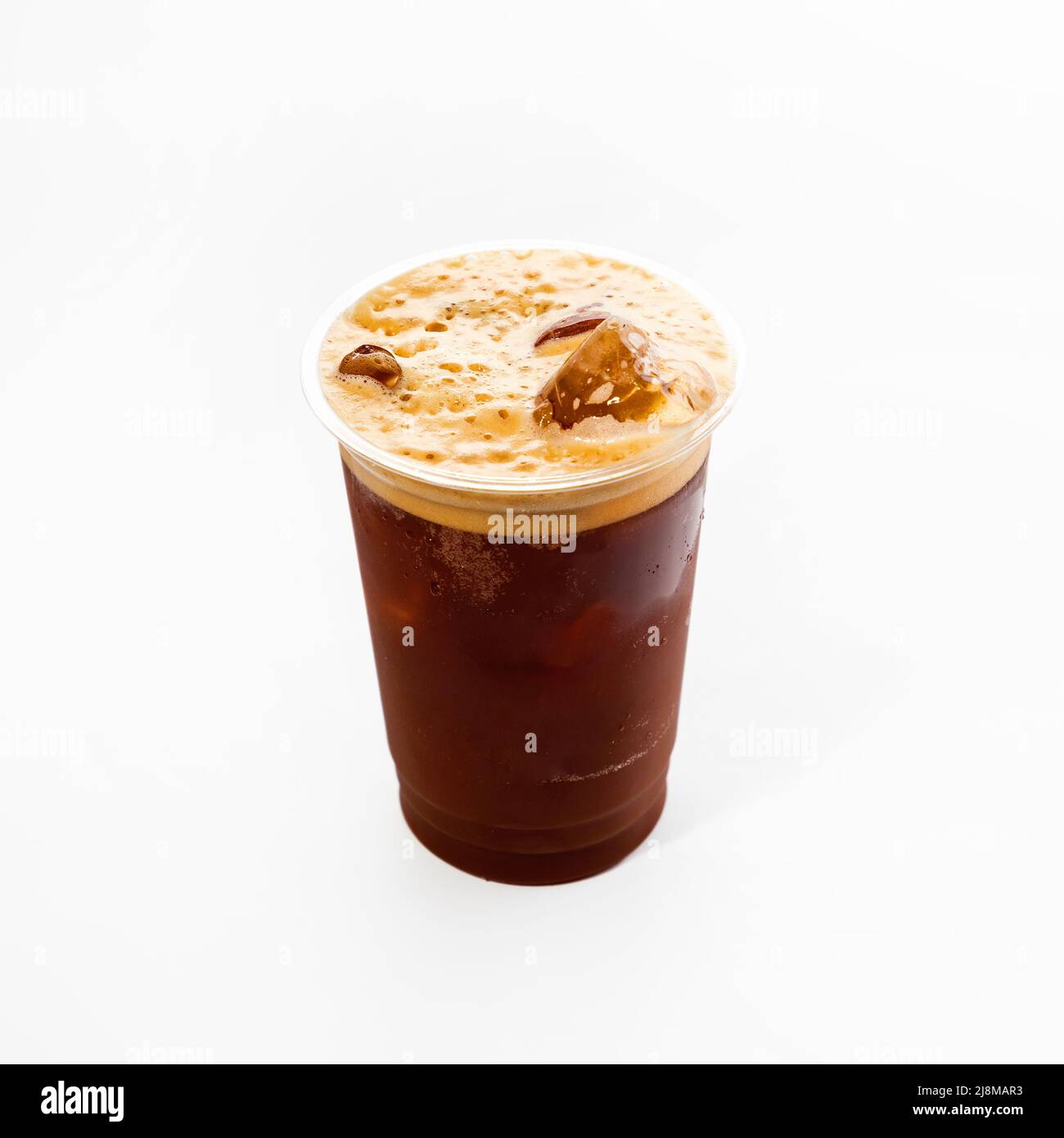 Plastic transparent glass with cold coffee frappe with ice cubes on a ...