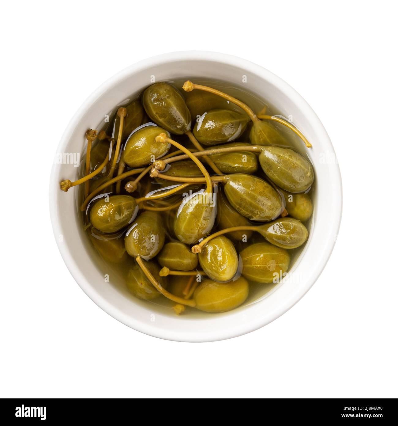 Pickled caper berries in a white bowl isolated on white background ...