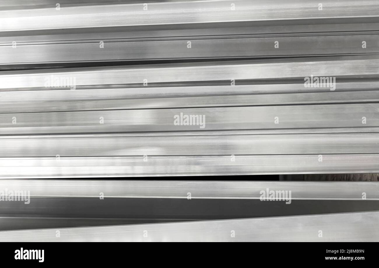 Steel rolled metal products. Stack of square, steel rods Stock Photo ...