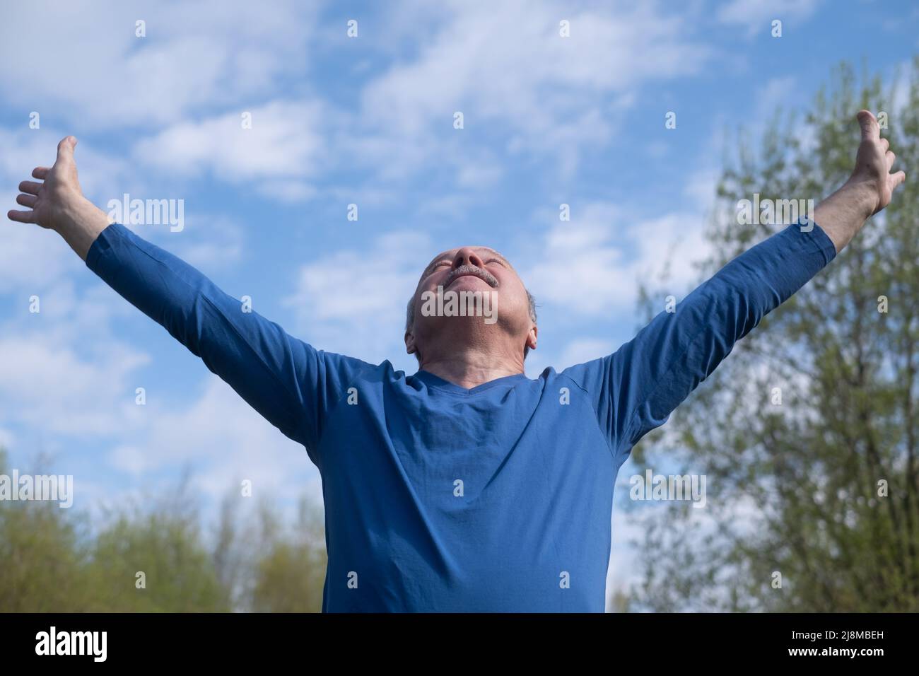 Senior runner with armband doing stretching. Spring nature. Healthy ...