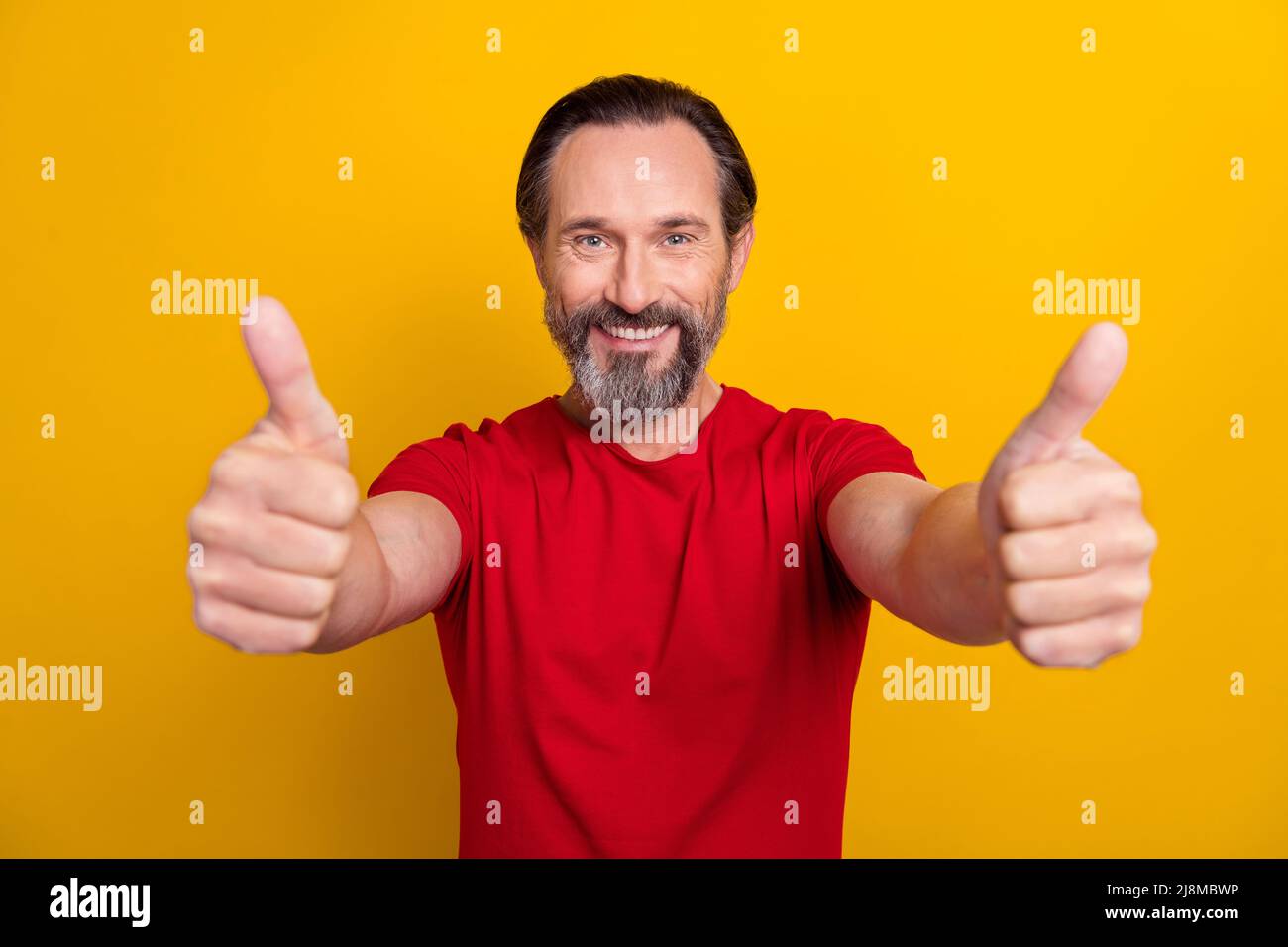 Photo of impressed mature brunet man thumb up wear red t-shirt isolated ...