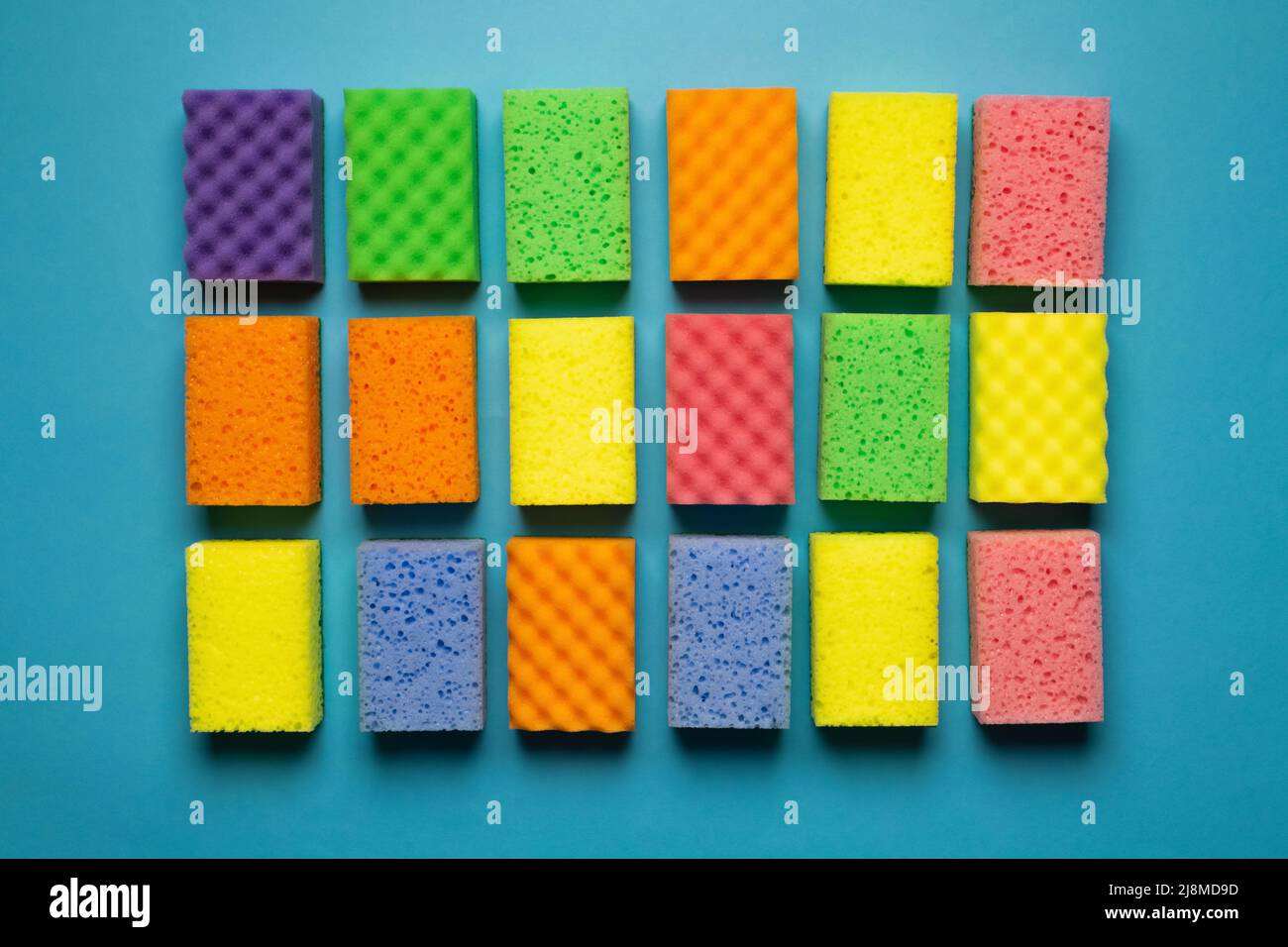 top view of different colorful kitchen washcloths on blue background ...