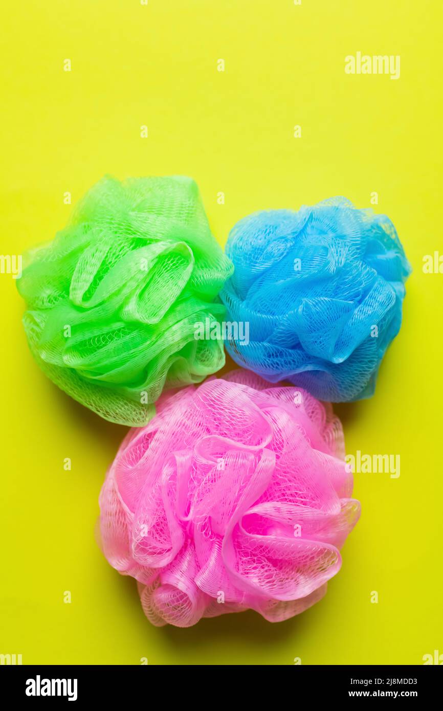top view of colorful exfoliating body puffs on yellow background Stock ...