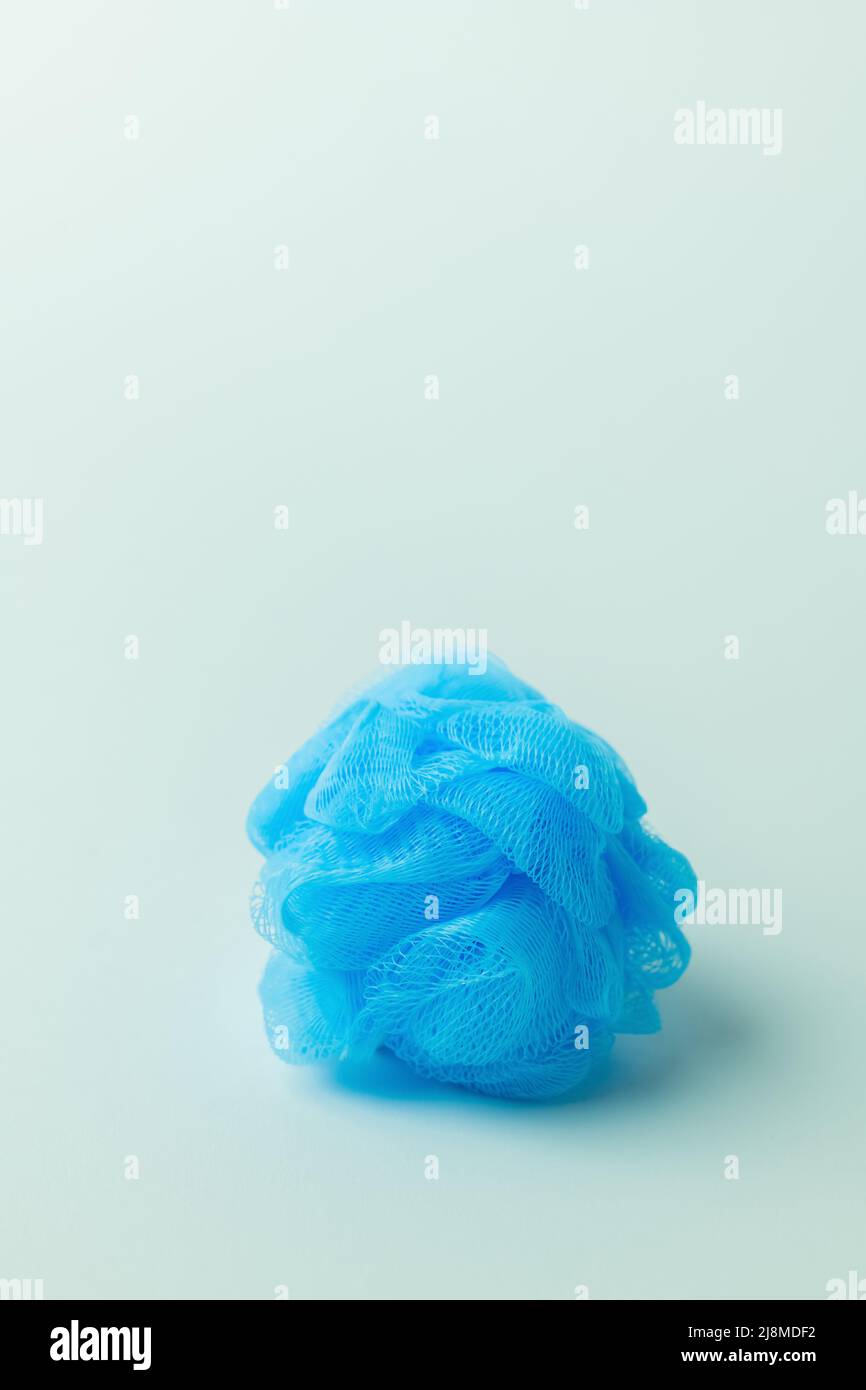 blue mesh washcloth on grey background with copy space Stock Photo - Alamy