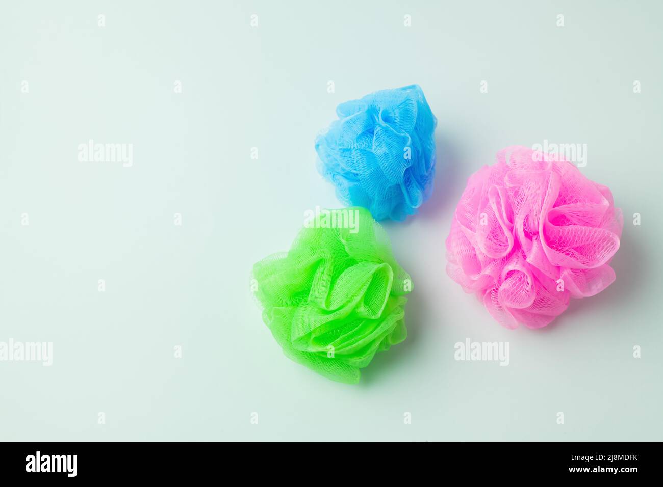 top view of colorful mesh body puffs on grey background Stock Photo - Alamy