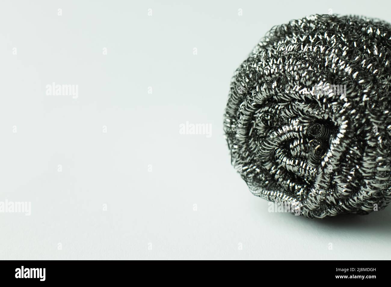 close up view of metal wire scourer on grey background with copy space ...