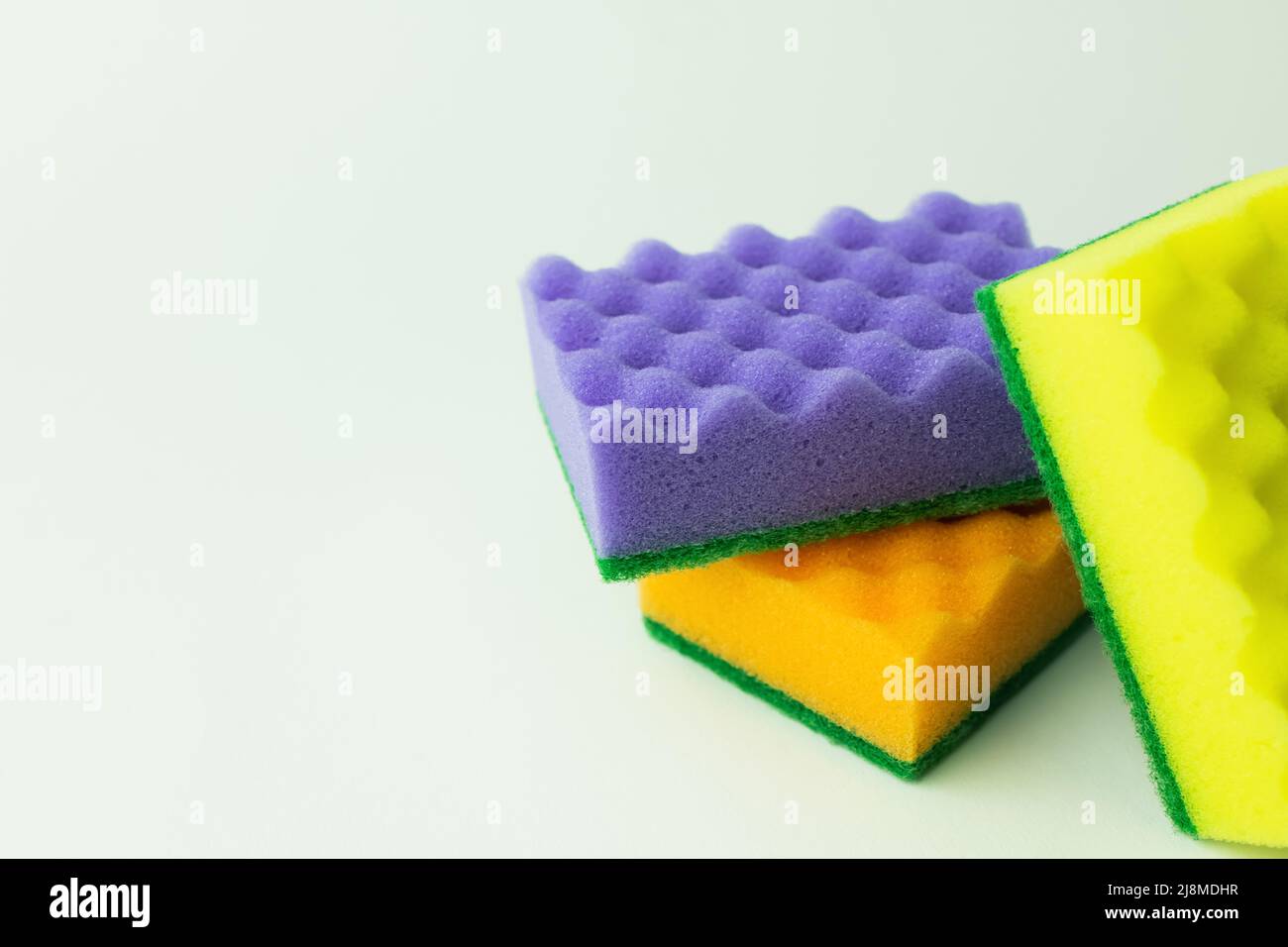 purple, orange and yellow sponges on grey background Stock Photo - Alamy