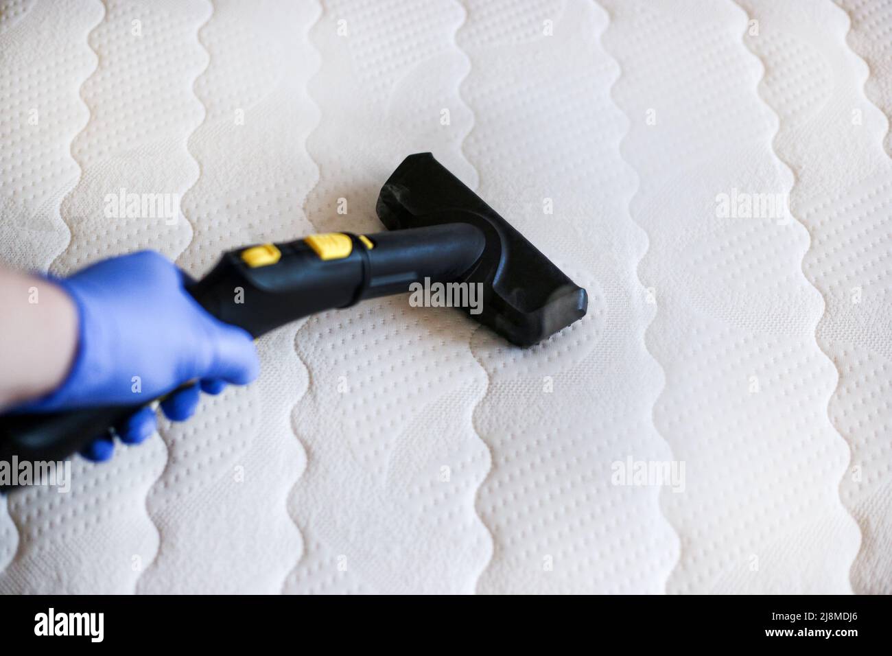 Cleaning and disinfection of the mattress in the bedroom with hot steam ...