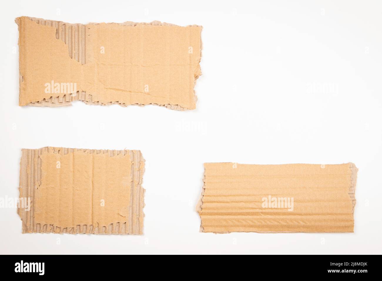 Three pieces of brown corrugated cardboard on white background. Blank ...