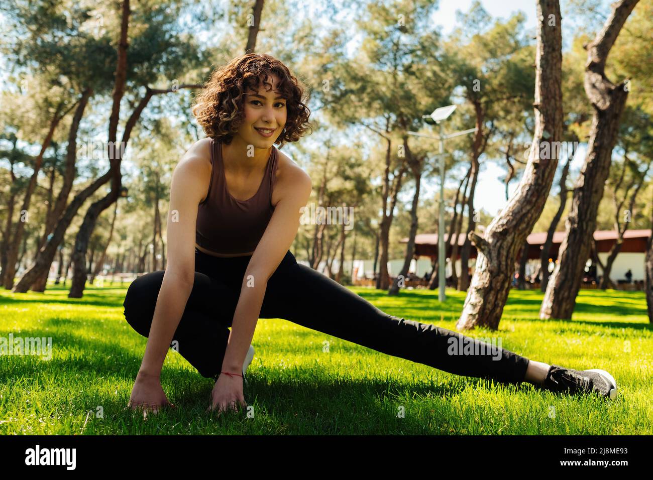 Sport and people concept. Photo of athletic female stretch after ...