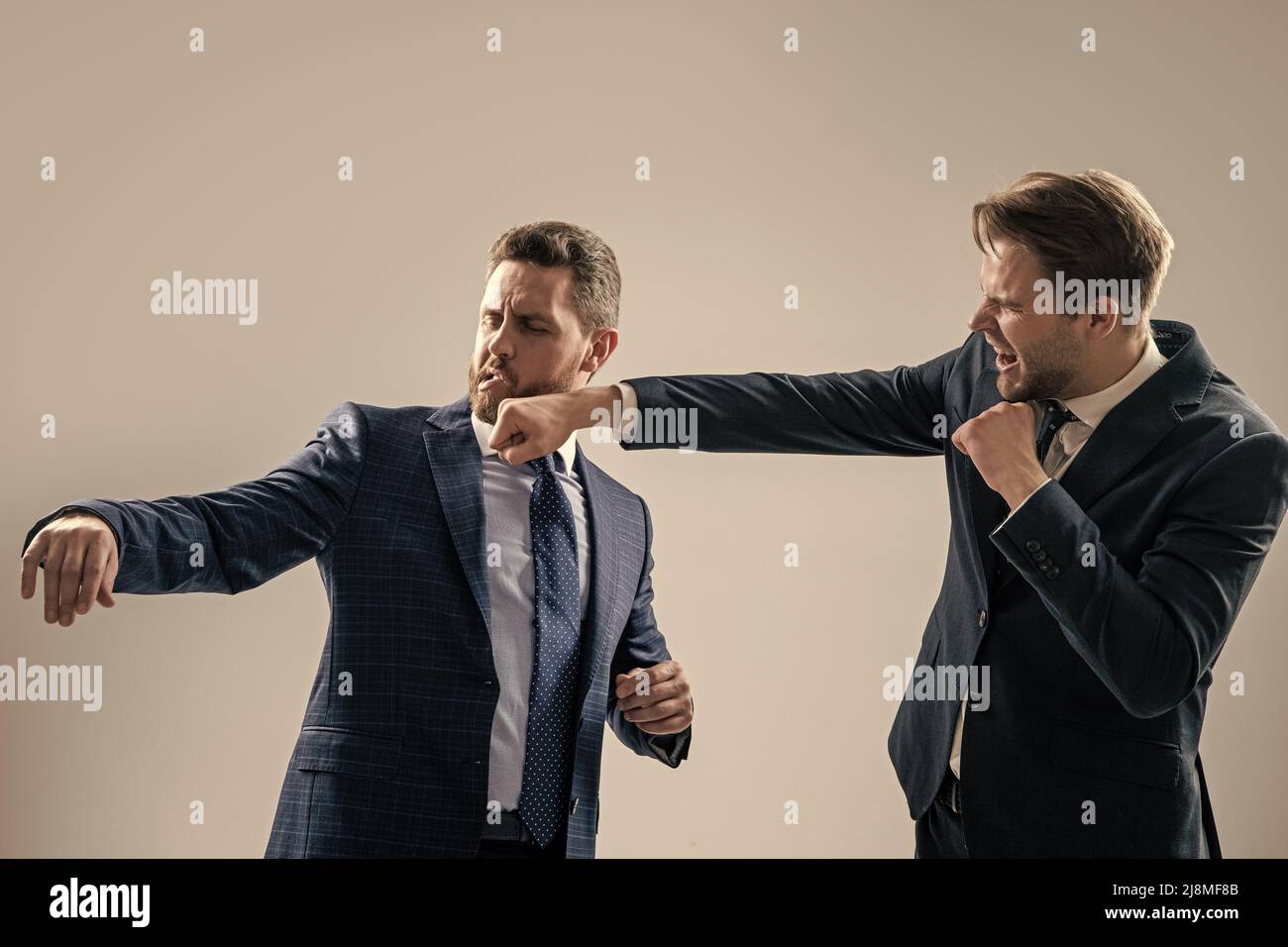 fist in face. colleagues have disagreement conflict. businessmen ...