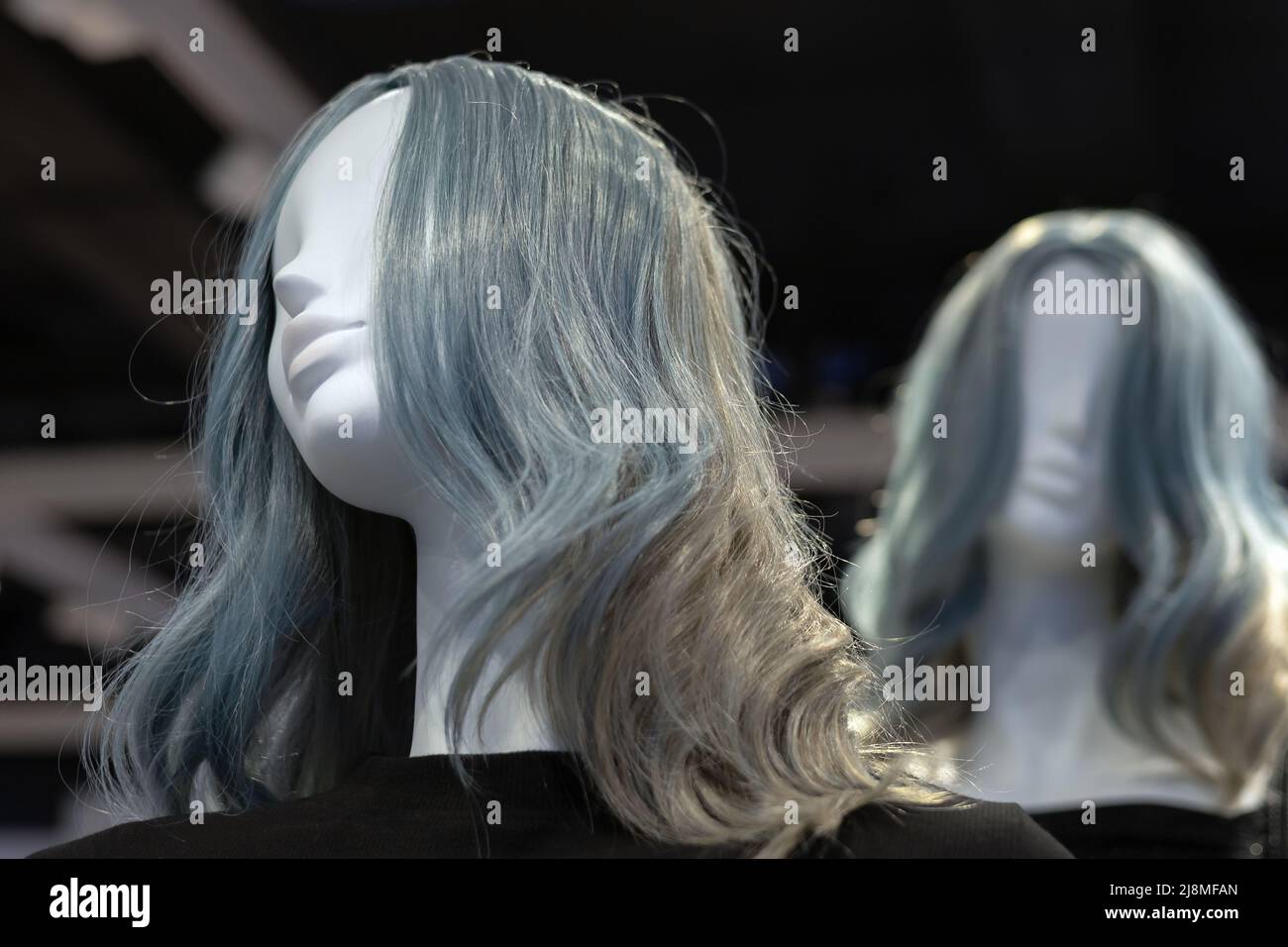 The head of female mannequin with gray hair against the background of ...