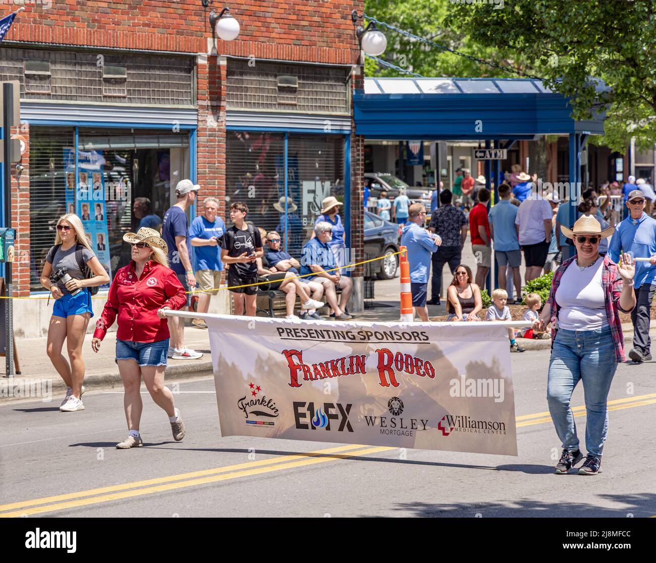 women carrying a banner for the Franklin Rodeo Stock Photo - Alamy
