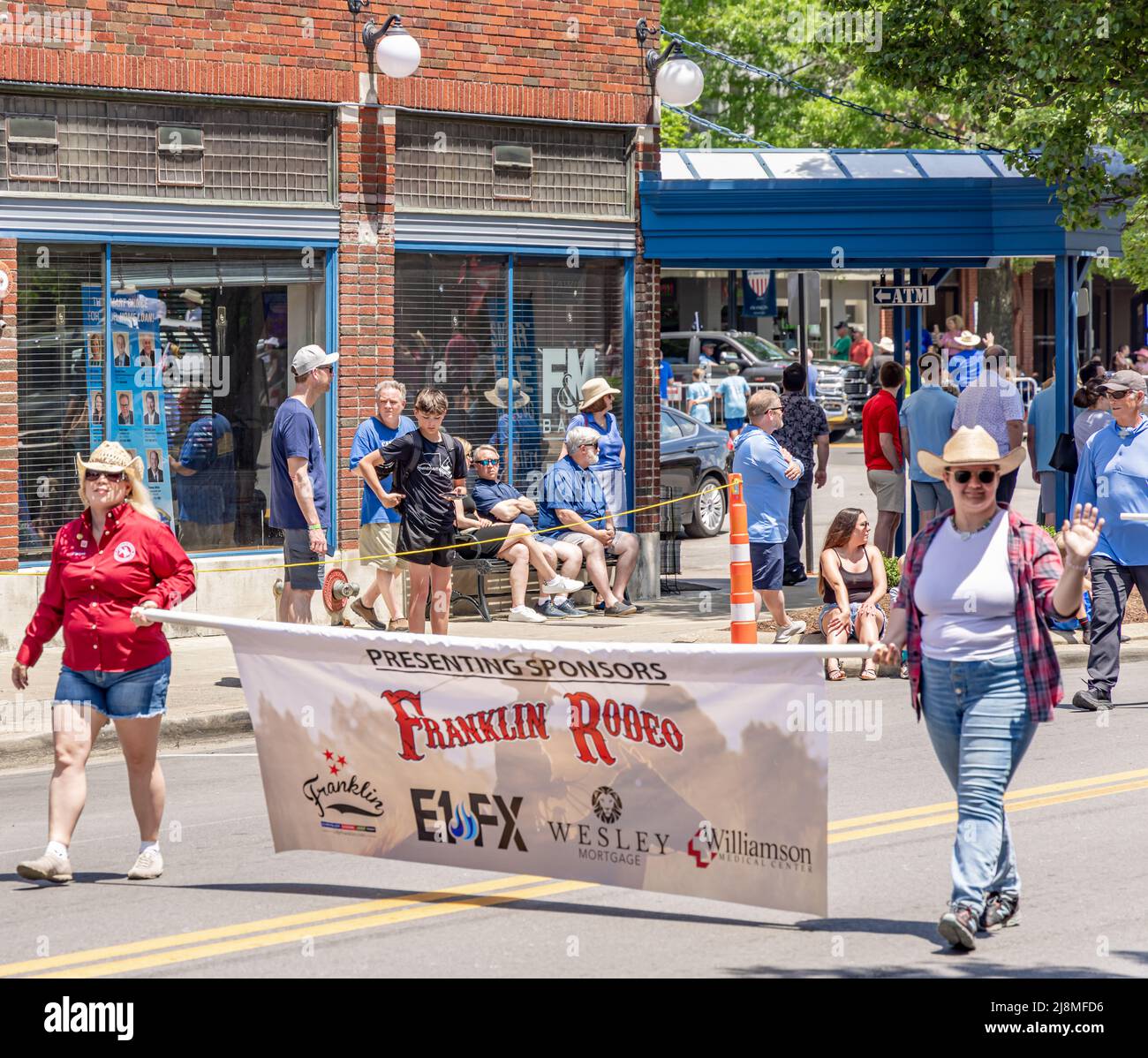 women carrying a banner for the Franklin Rodeo Stock Photo - Alamy