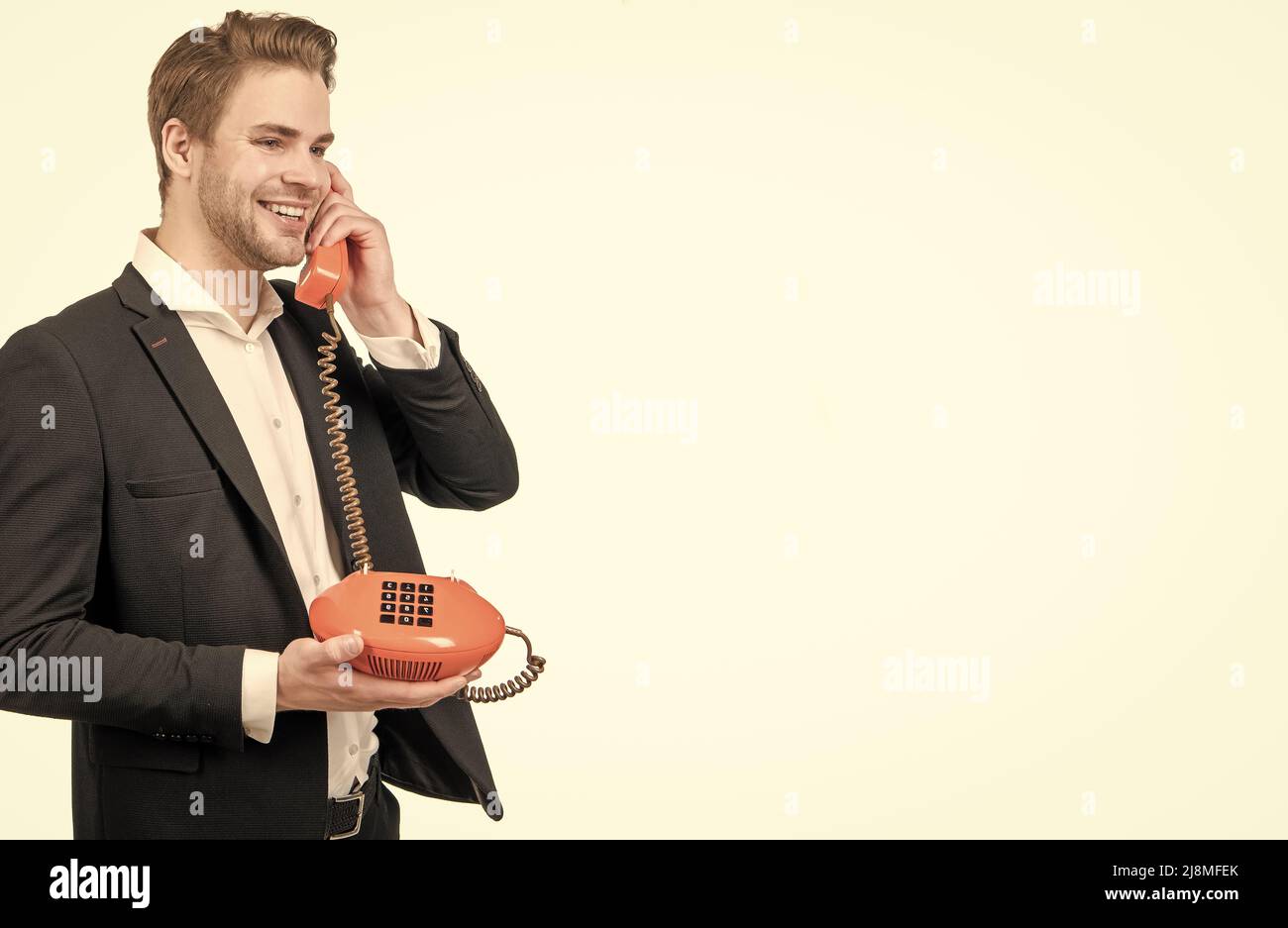 Happy professional man talk on old-fashioned vintage telephone call ...