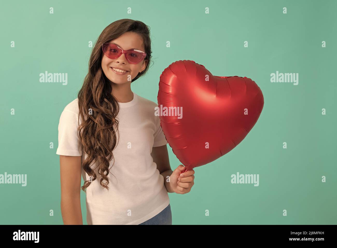 teen girl with party balloon. love present. happy smiling kid with love ...