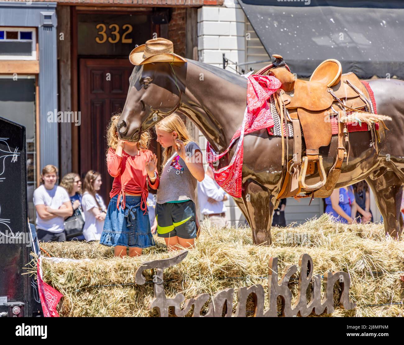 two young girls and plastic horse on a parade float Stock Photo - Alamy