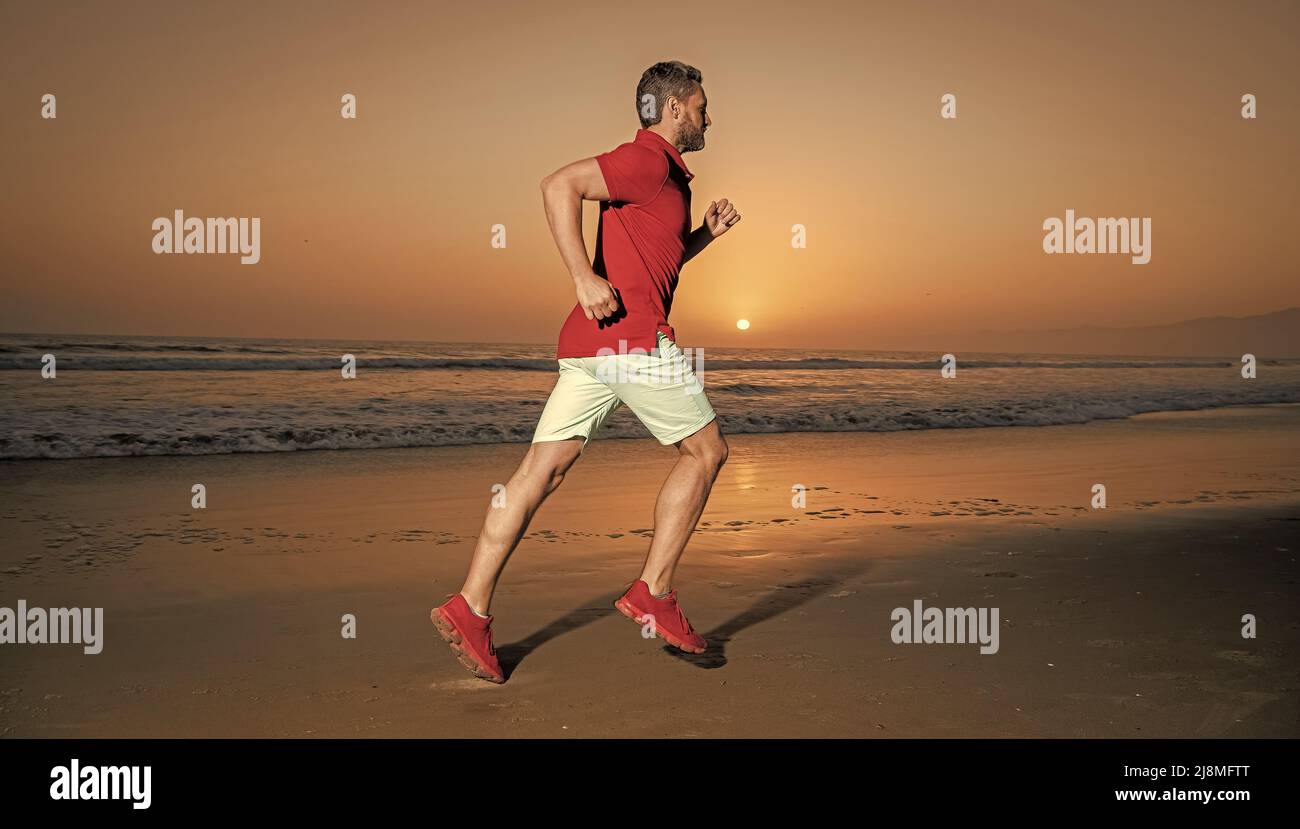 healthy man running on sunrise beach. energetic summer. runner feel ...