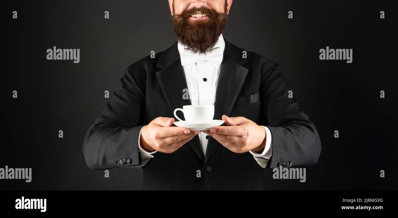 cropped happy man in tuxedo bow tie with coffee cup. waiter in ...