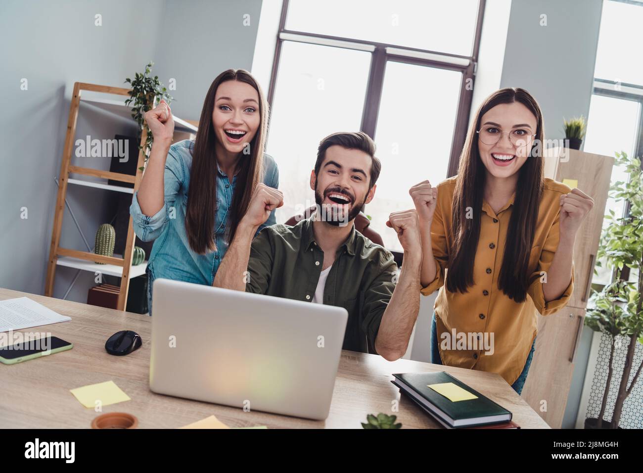 Photo of happy excited assistants successful project modern technology ...