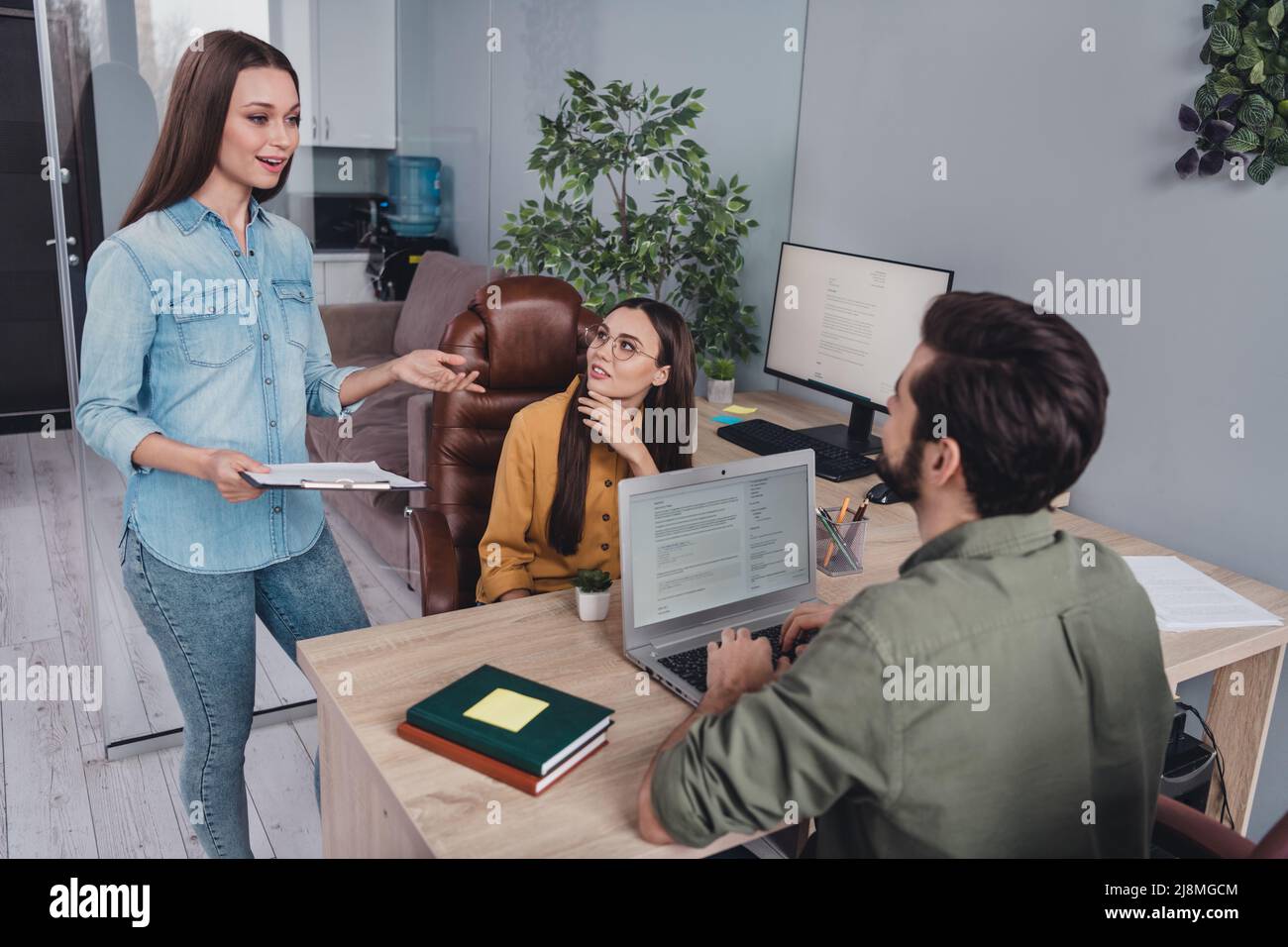 Portrait of three startup partners communicate speak analyzing ...