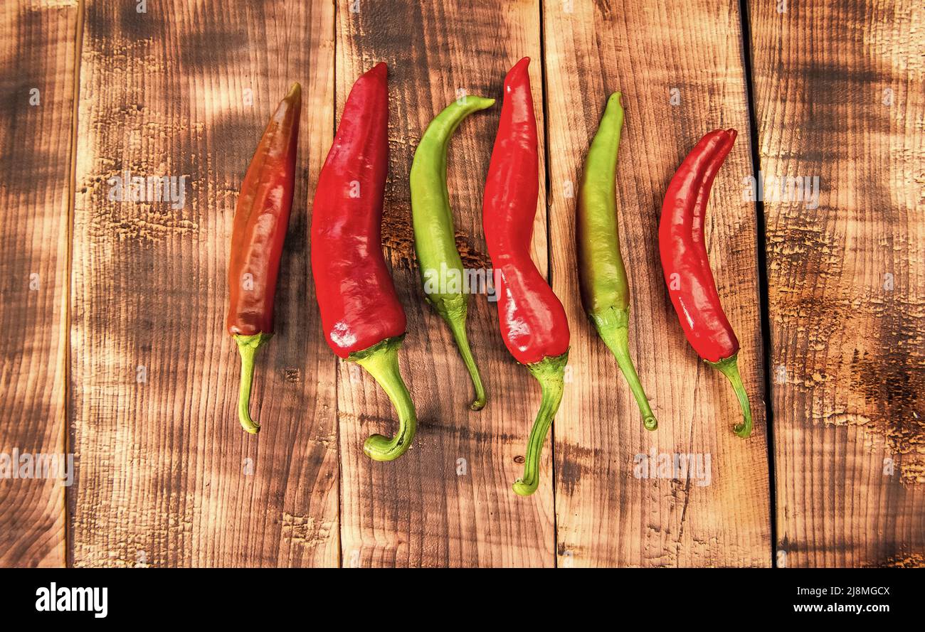Chili peppers on wooden background. Red and green chile peppers ...