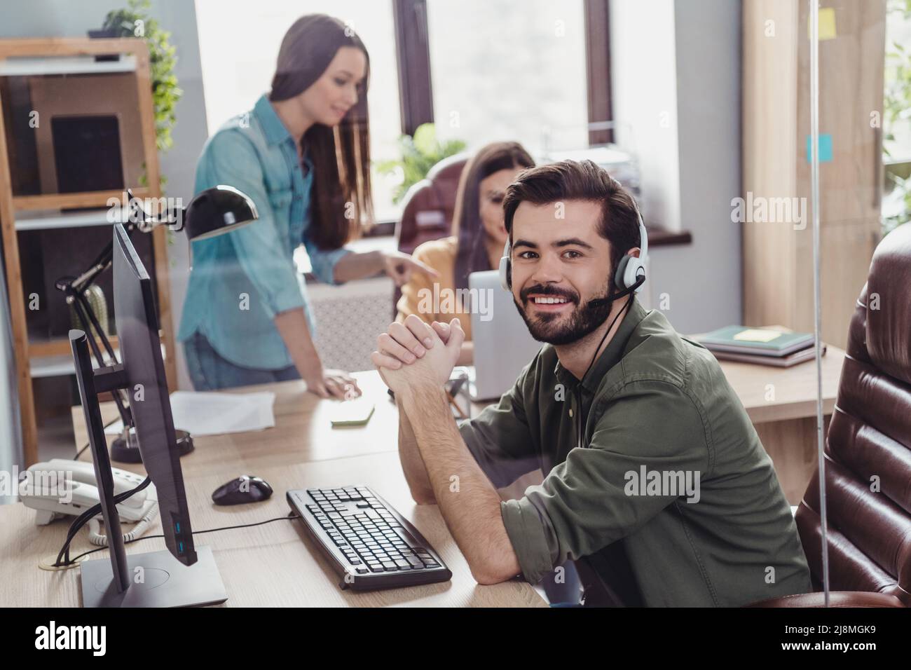 Photo of three employee operator sitting chair communicate speak ...
