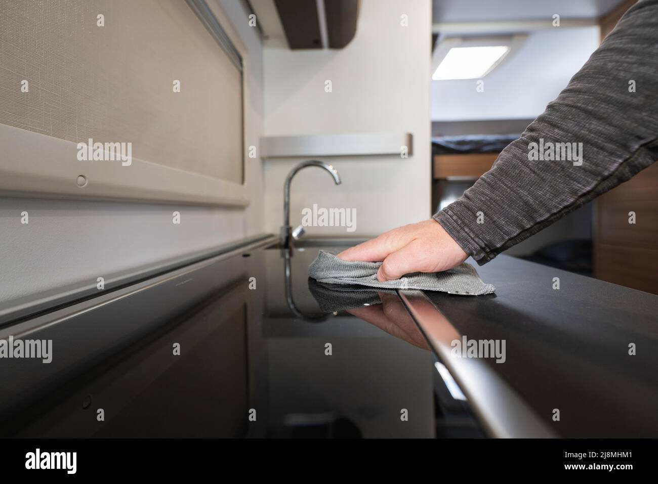 Caucasian Men Cleaning Motorhome Camper Van Kitchen Area with Soft ...