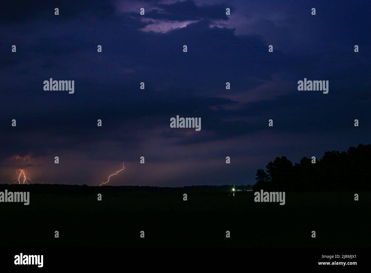 Late evening with dark cloudy sky with scatter lightning Stock Photo ...