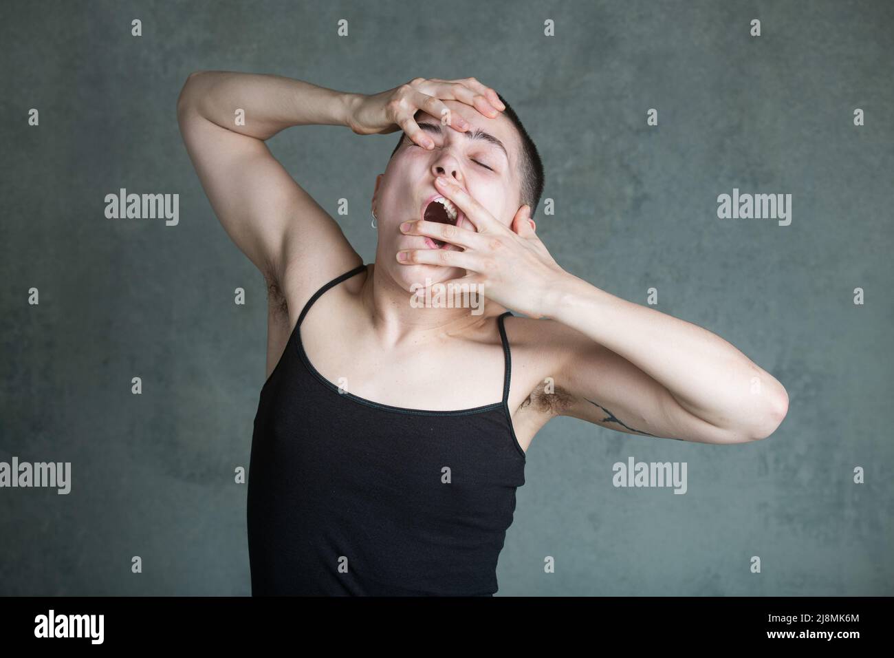 non binary pulling an angry, frustrated face Stock Photo - Alamy