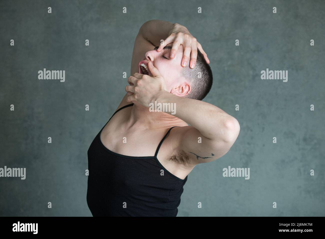 non binary pulling an angry, frustrated face Stock Photo - Alamy