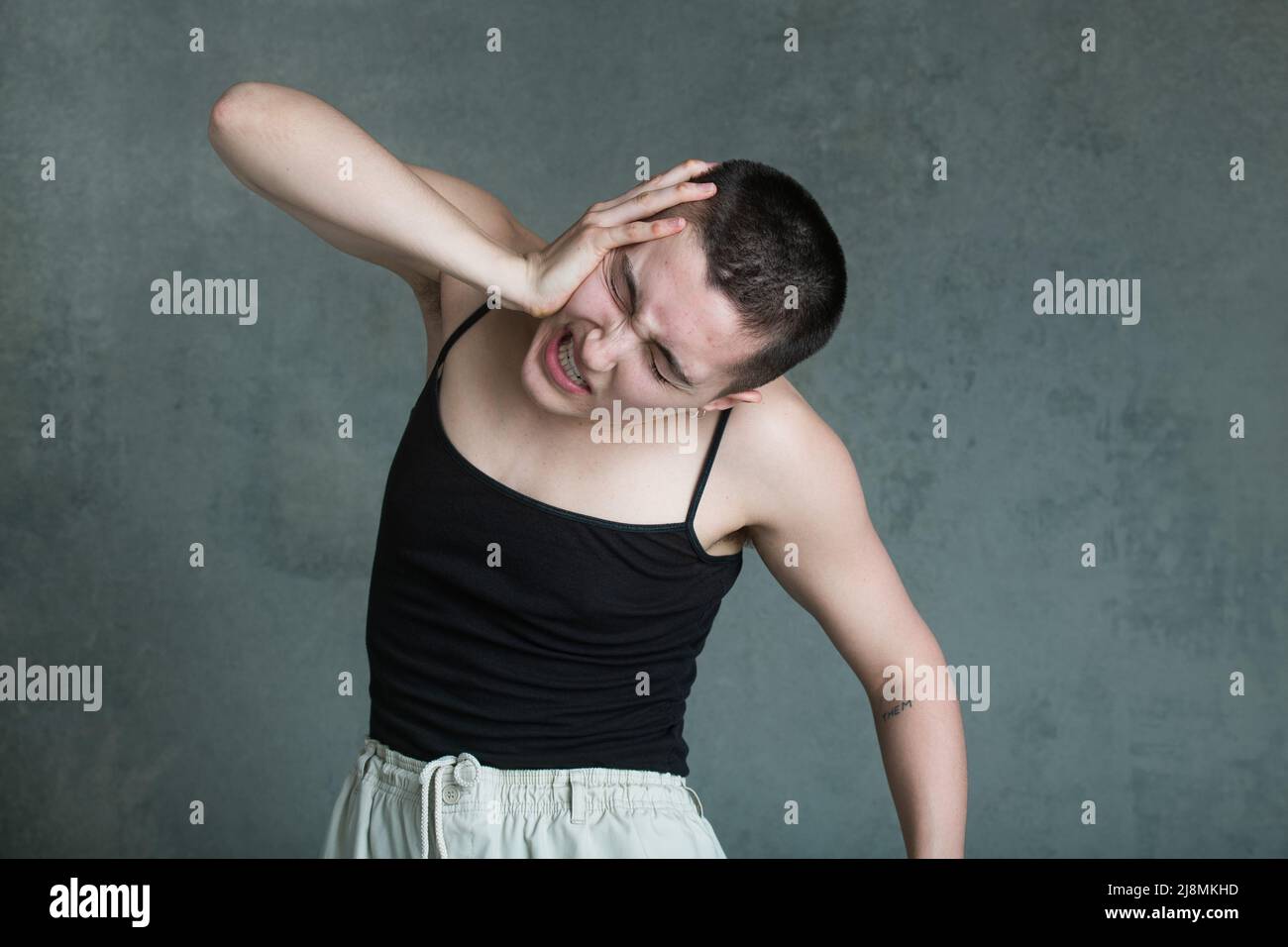 non binary pulling an angry, frustrated face Stock Photo - Alamy