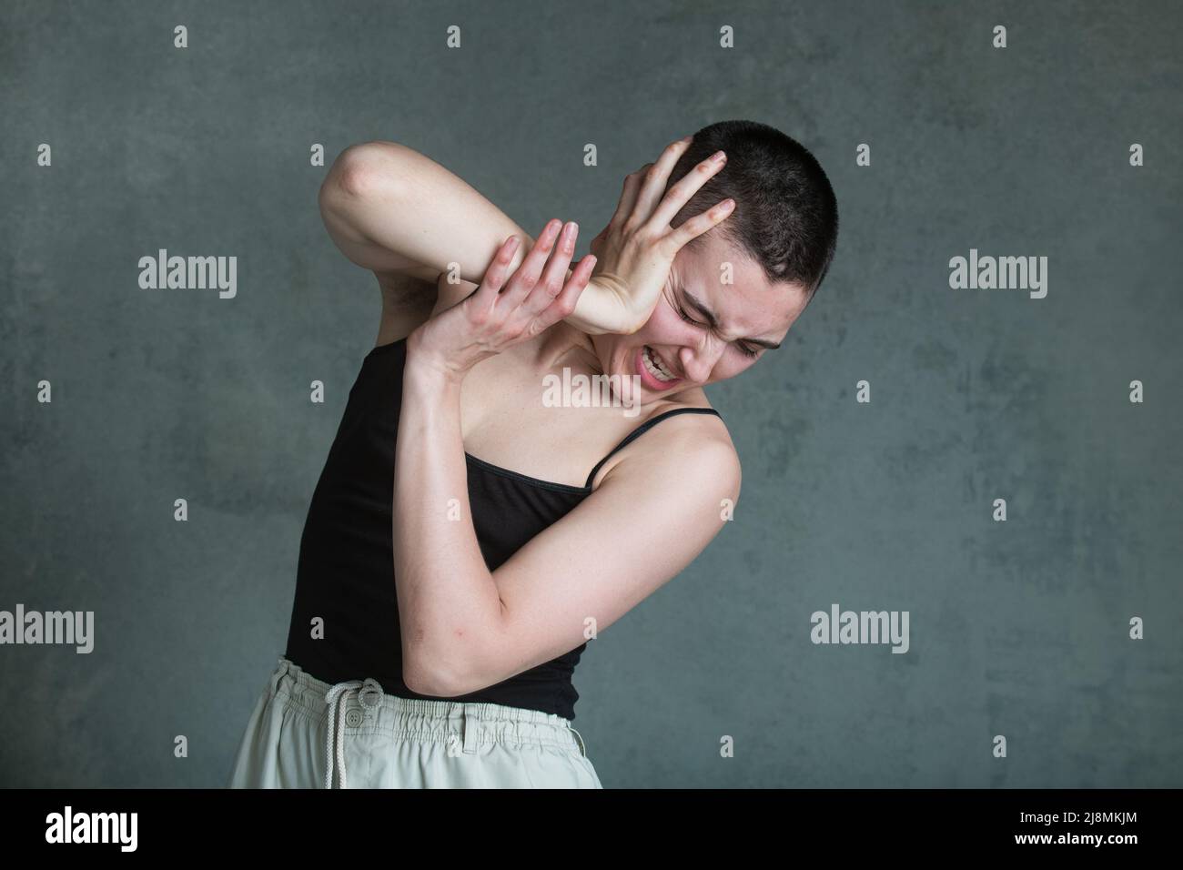 non binary pulling an angry, frustrated face Stock Photo - Alamy