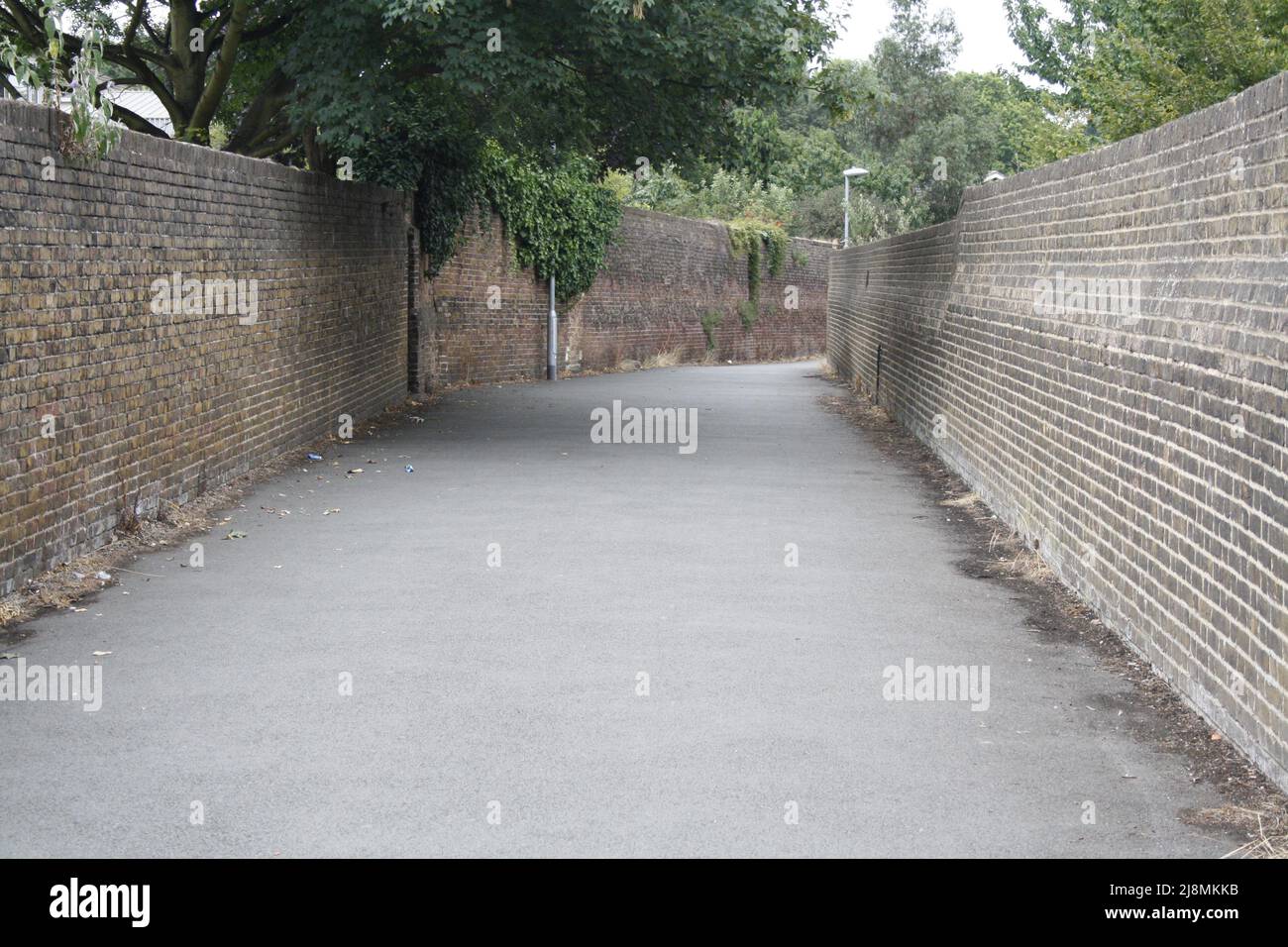 The alley between two brick walls Stock Photo - Alamy