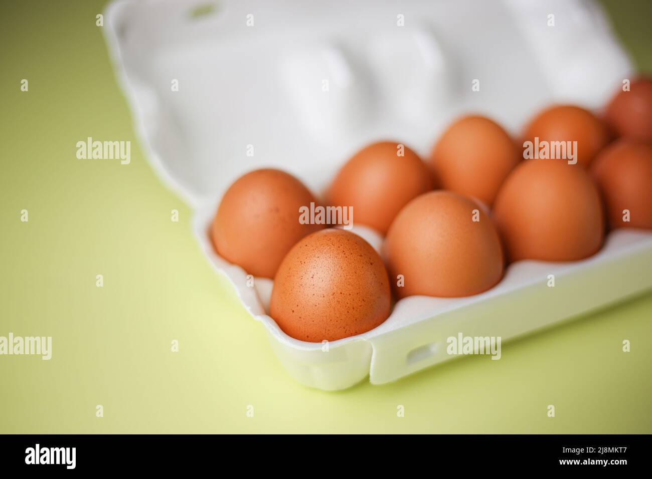 Brown eggs in expanded polystyrene packaging on an isolated light ...