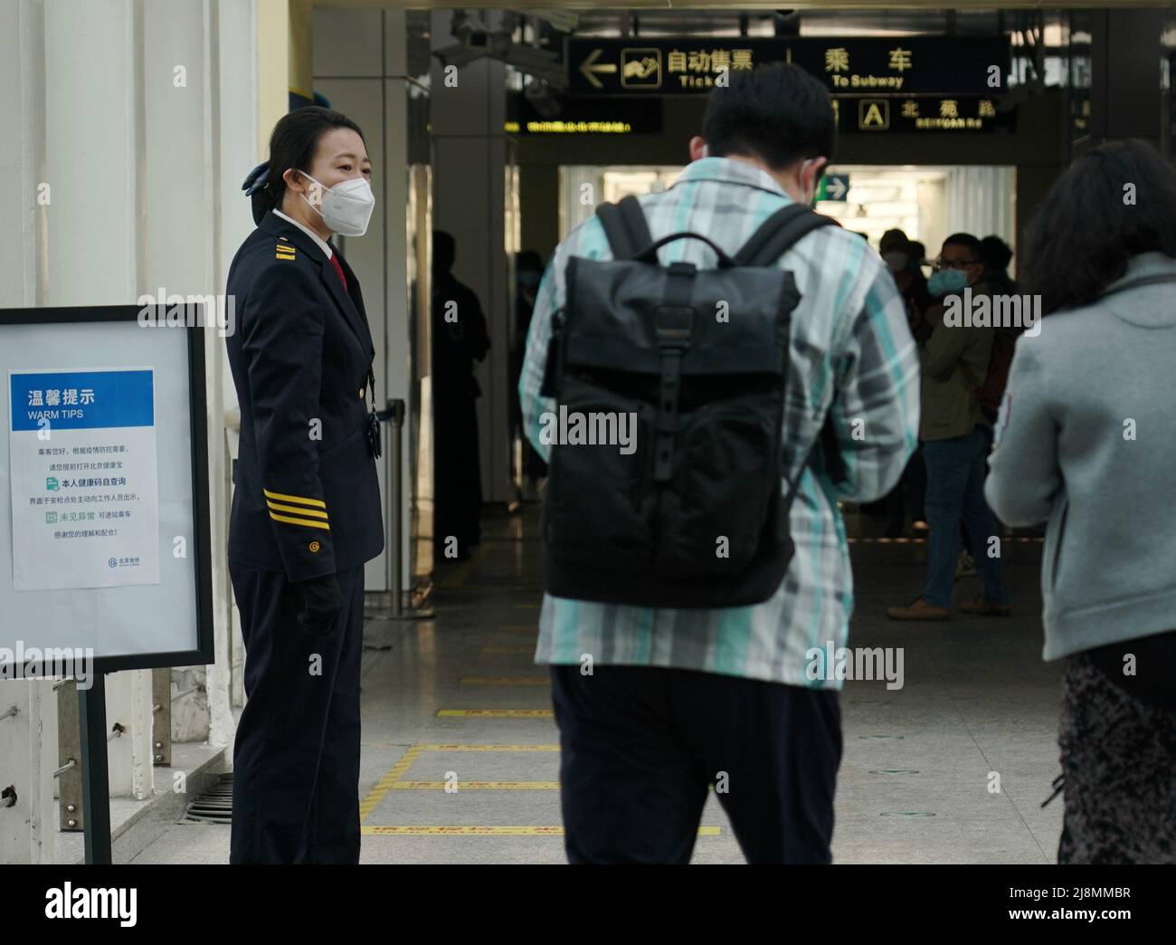 Beijing, China. 17th May, 2022. A staff member reminds passengers of ...