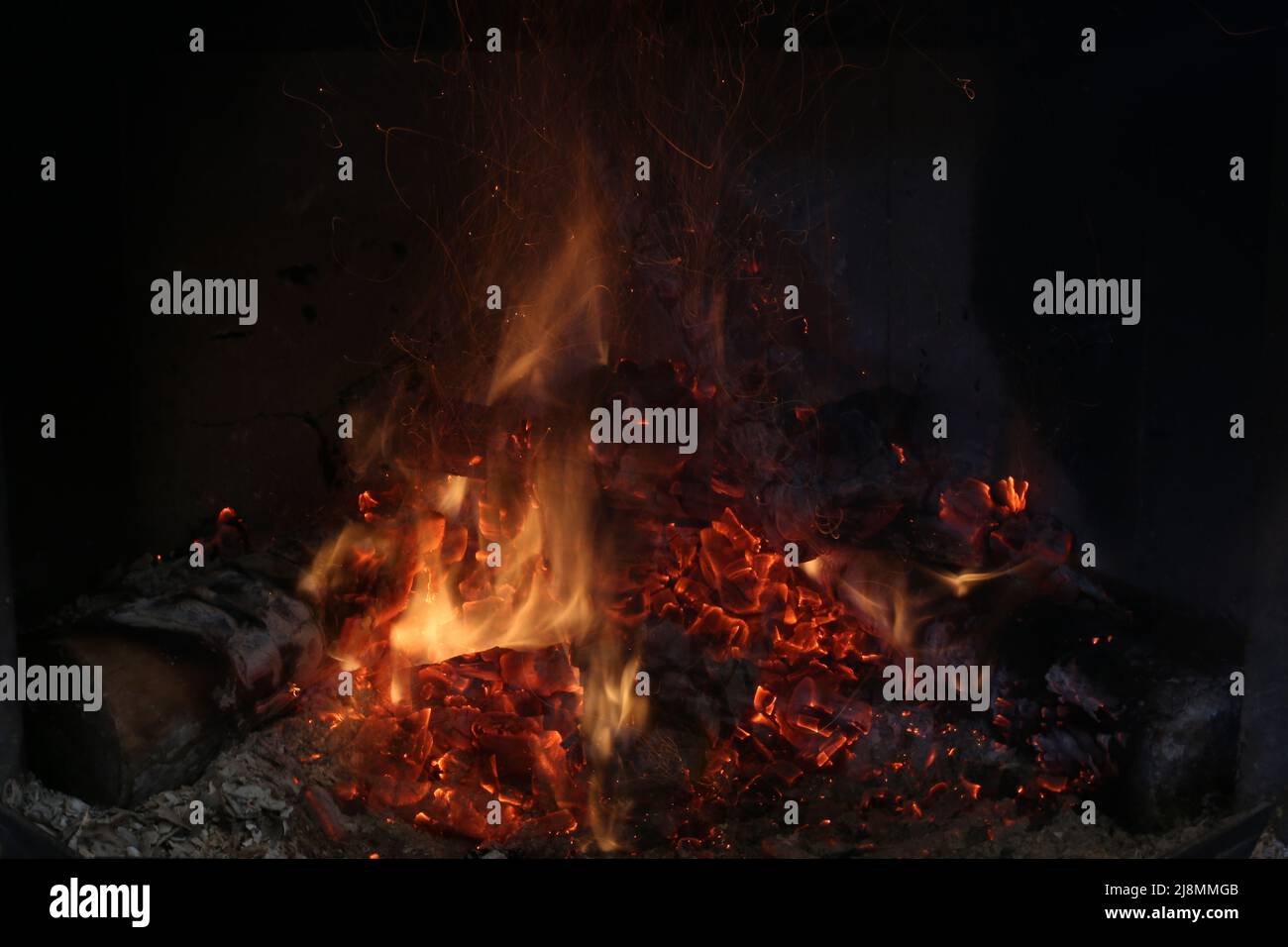 Bright burning wood in a fireplace with sparks close-up Stock Photo - Alamy