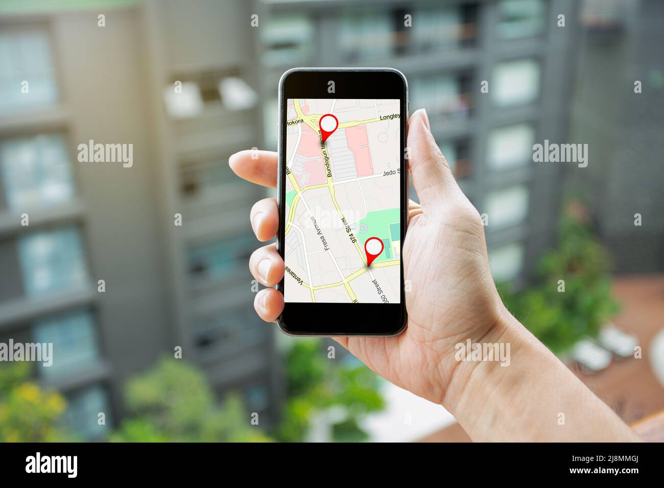 Man hand holding smartphone with GPS Map to Route Destination network ...