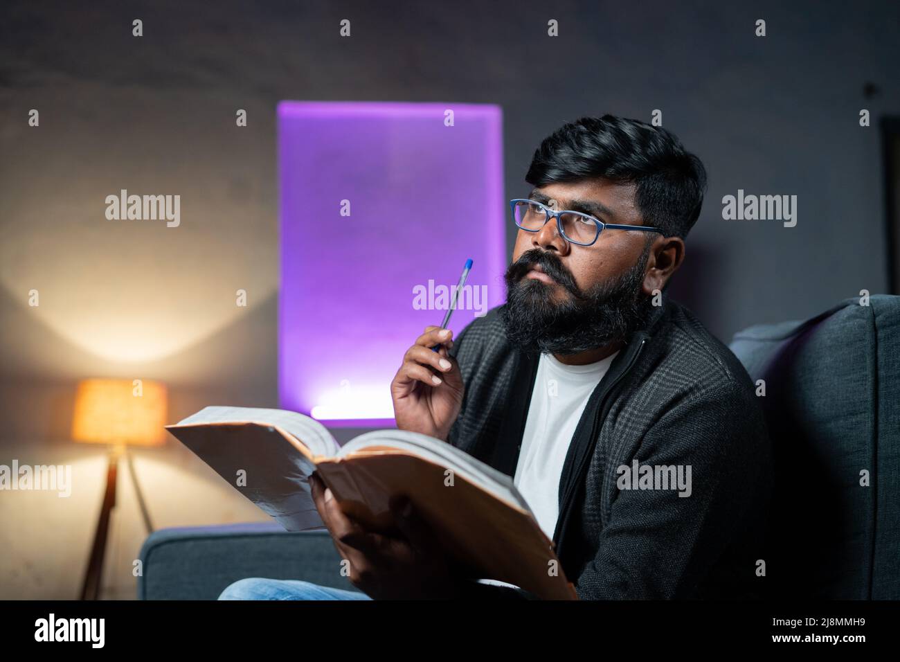 Man holding book and pen hi-res stock photography and images - Alamy