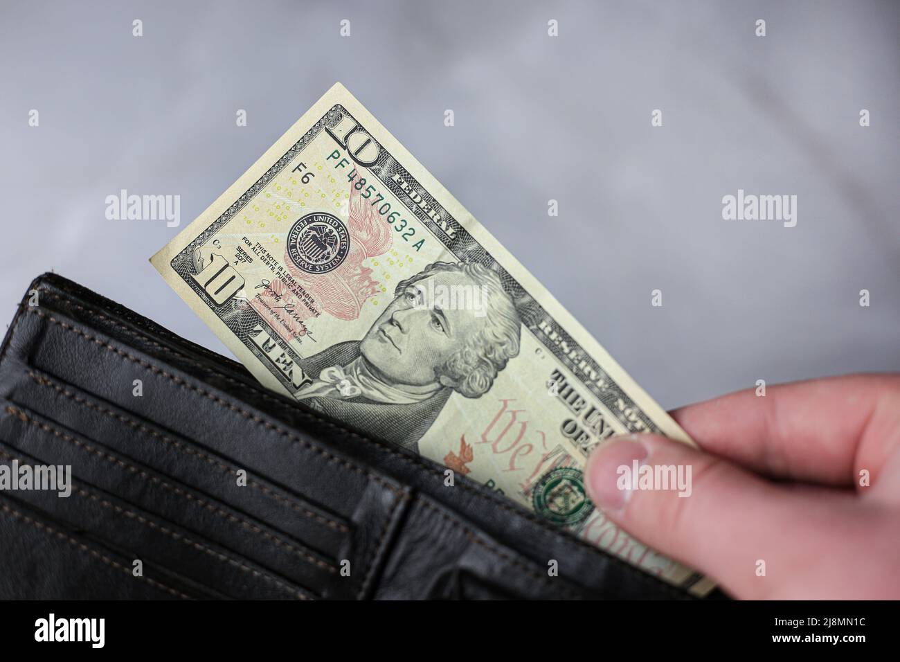 Opening wallet with 10 dollar bill Stock Photo - Alamy