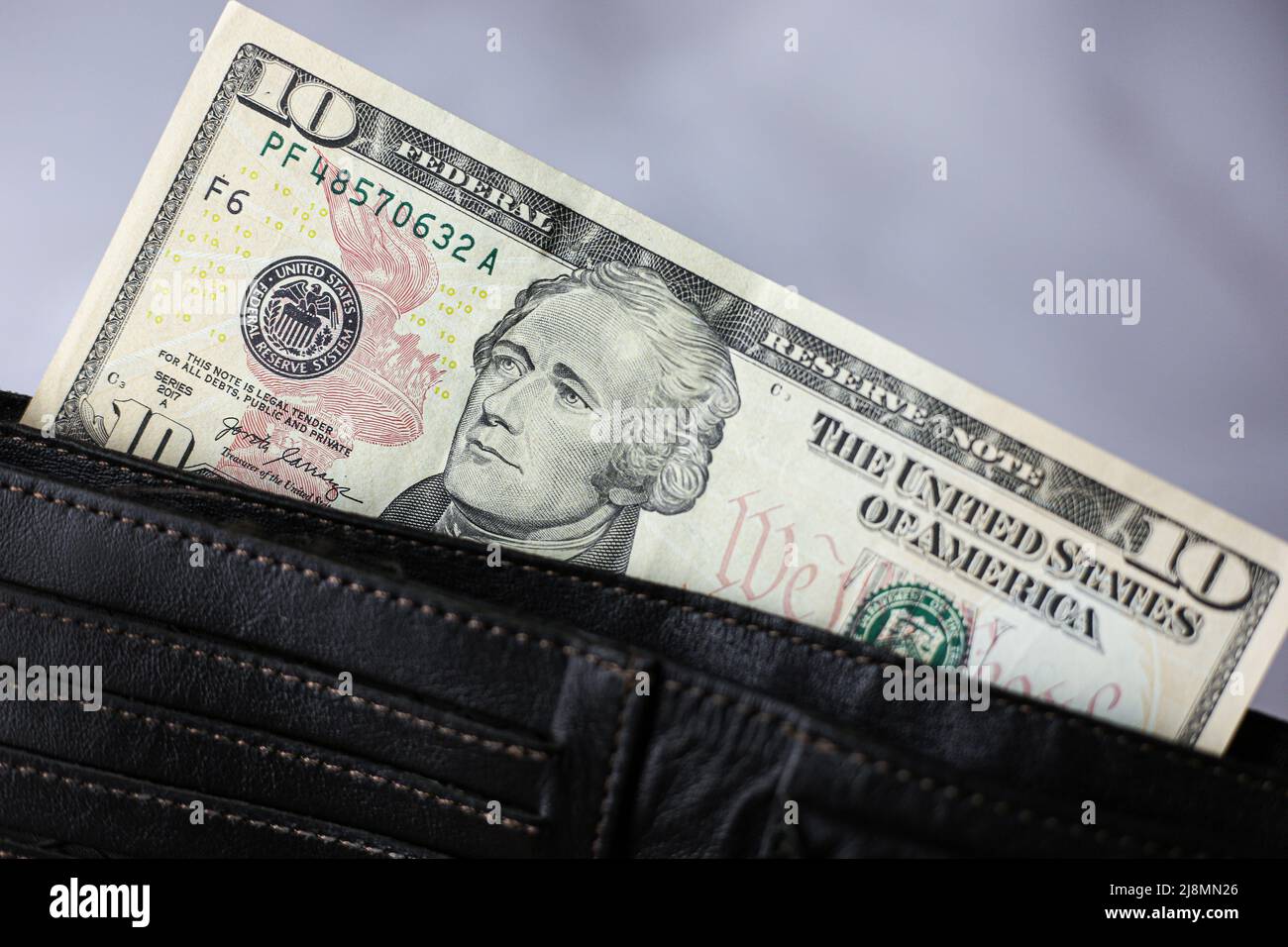 10 dollar banknote in a dark leather wallet on a light background Stock ...