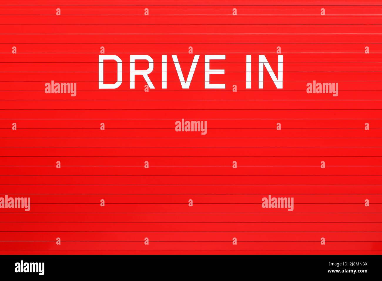 Drive in sign on a red wall Stock Photo - Alamy