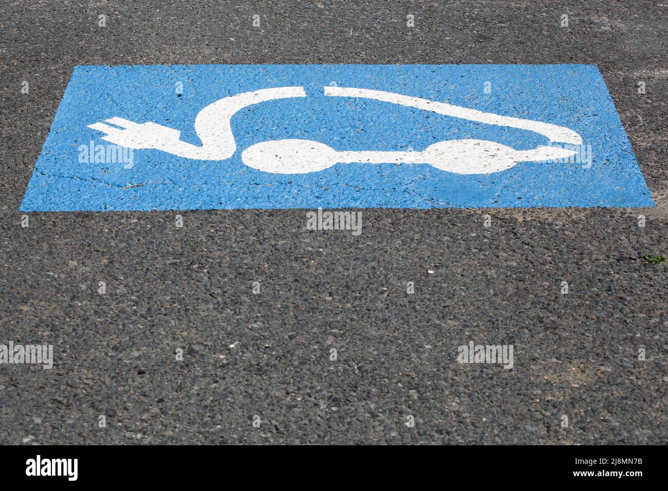 Electric car charging symbol on a parking Stock Photo - Alamy