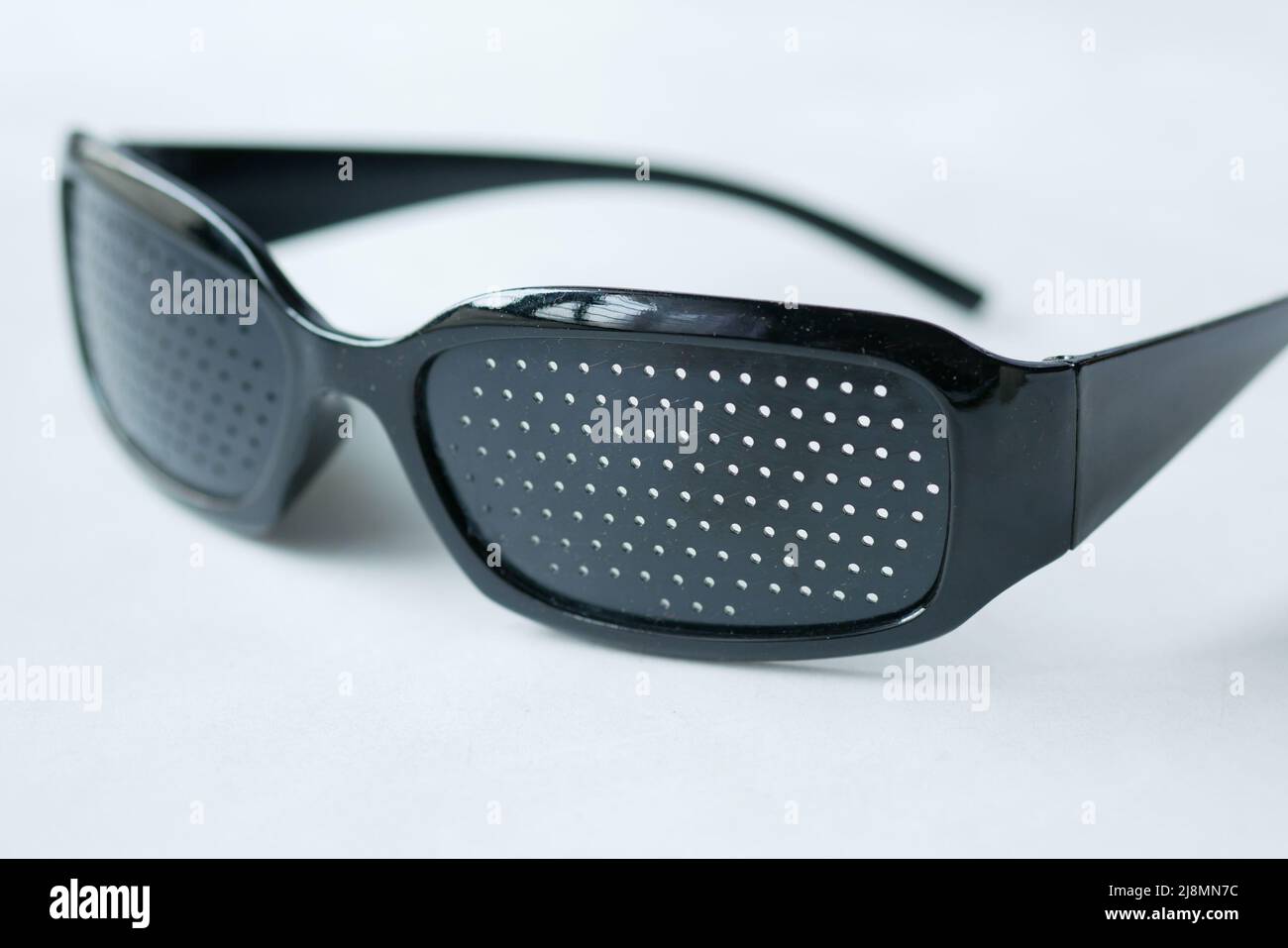 Perforation glasses with holes for training vision Stock Photo - Alamy