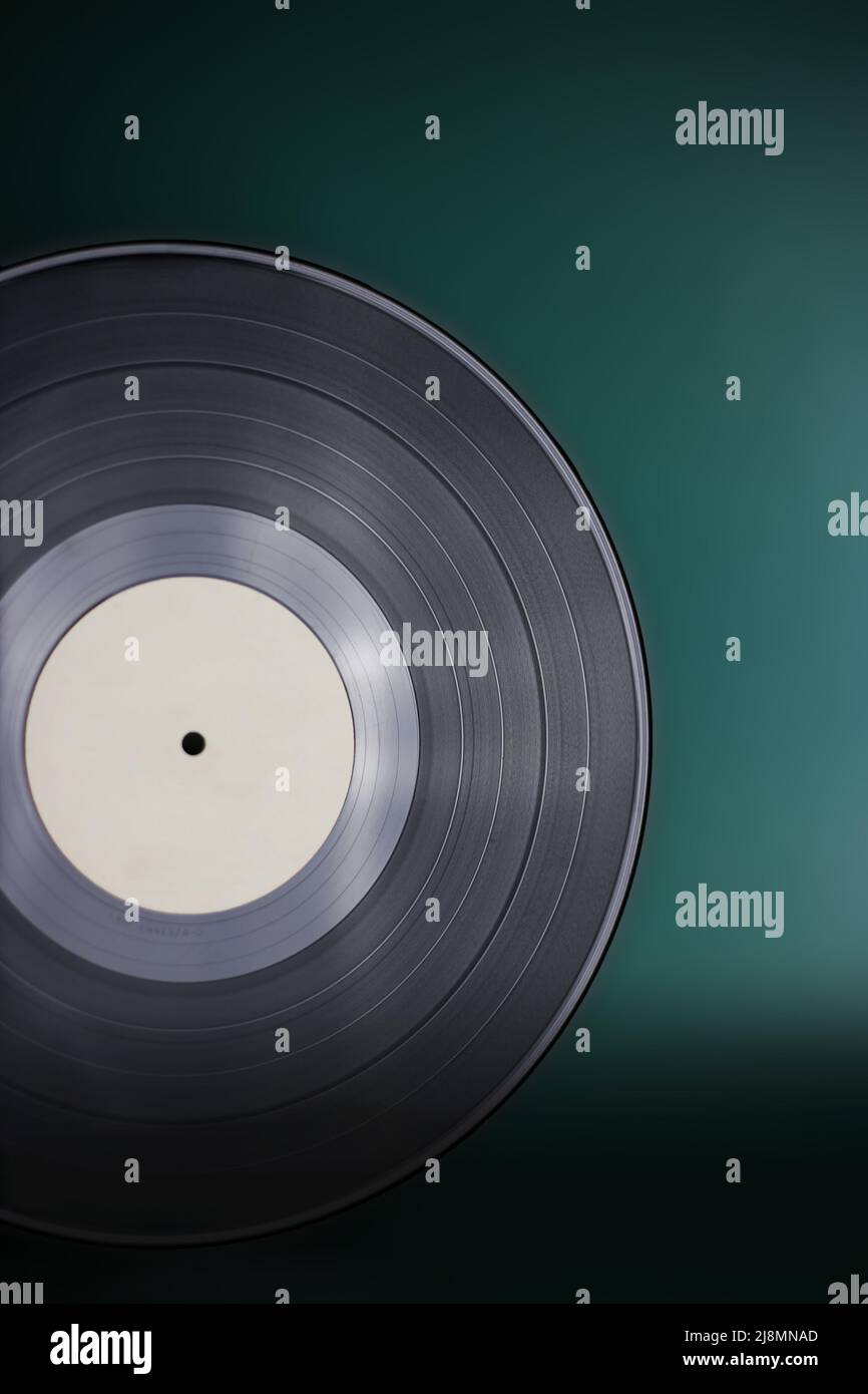 Classic vinyl record close-up on a green background, classical music ...