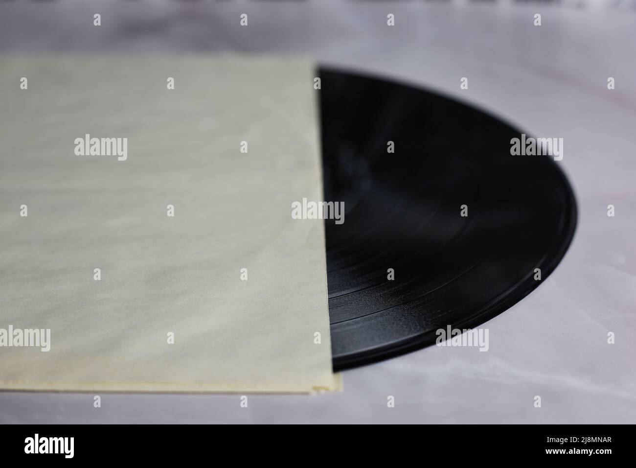 Classic vinyl record with packaging closeup on a light background ...