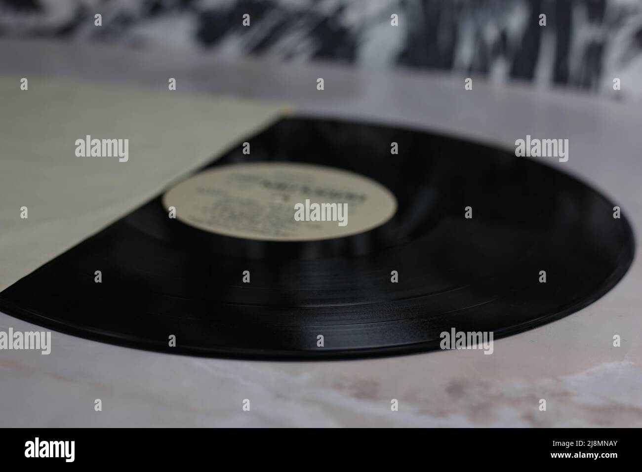 Classic vinyl record with packaging closeup on a light background ...