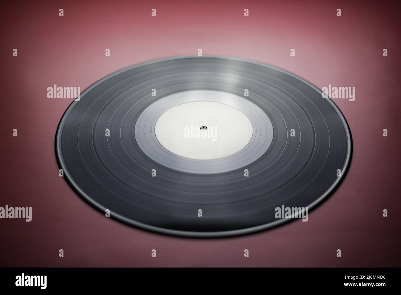 Classic vinyl record close-up on a red burgundy background, outdated ...