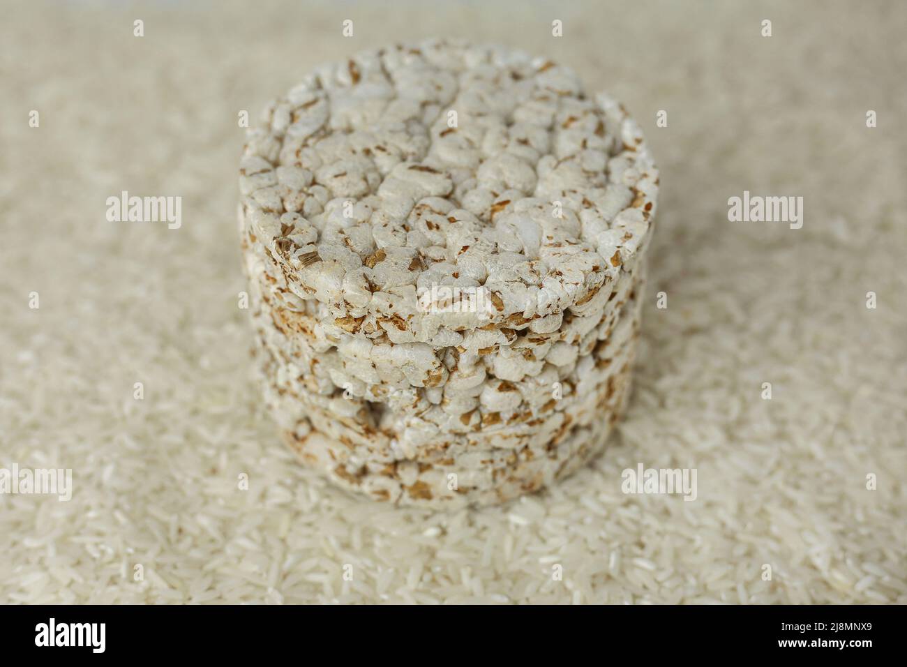 Rice buckwheat cake on a background of strewn rice groats Stock Photo ...
